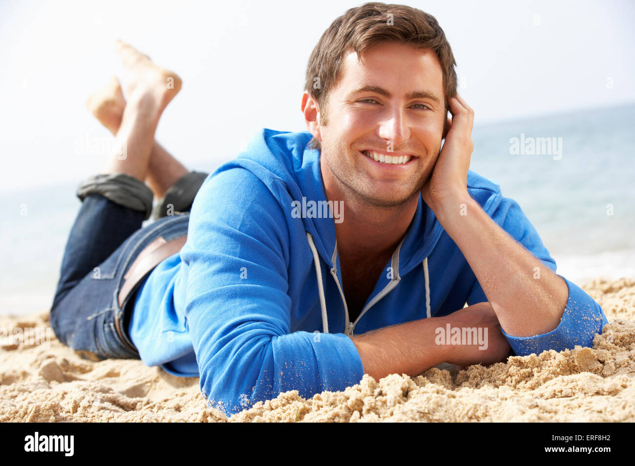 Man Relaxing On Beach Stock Photo - Alamy