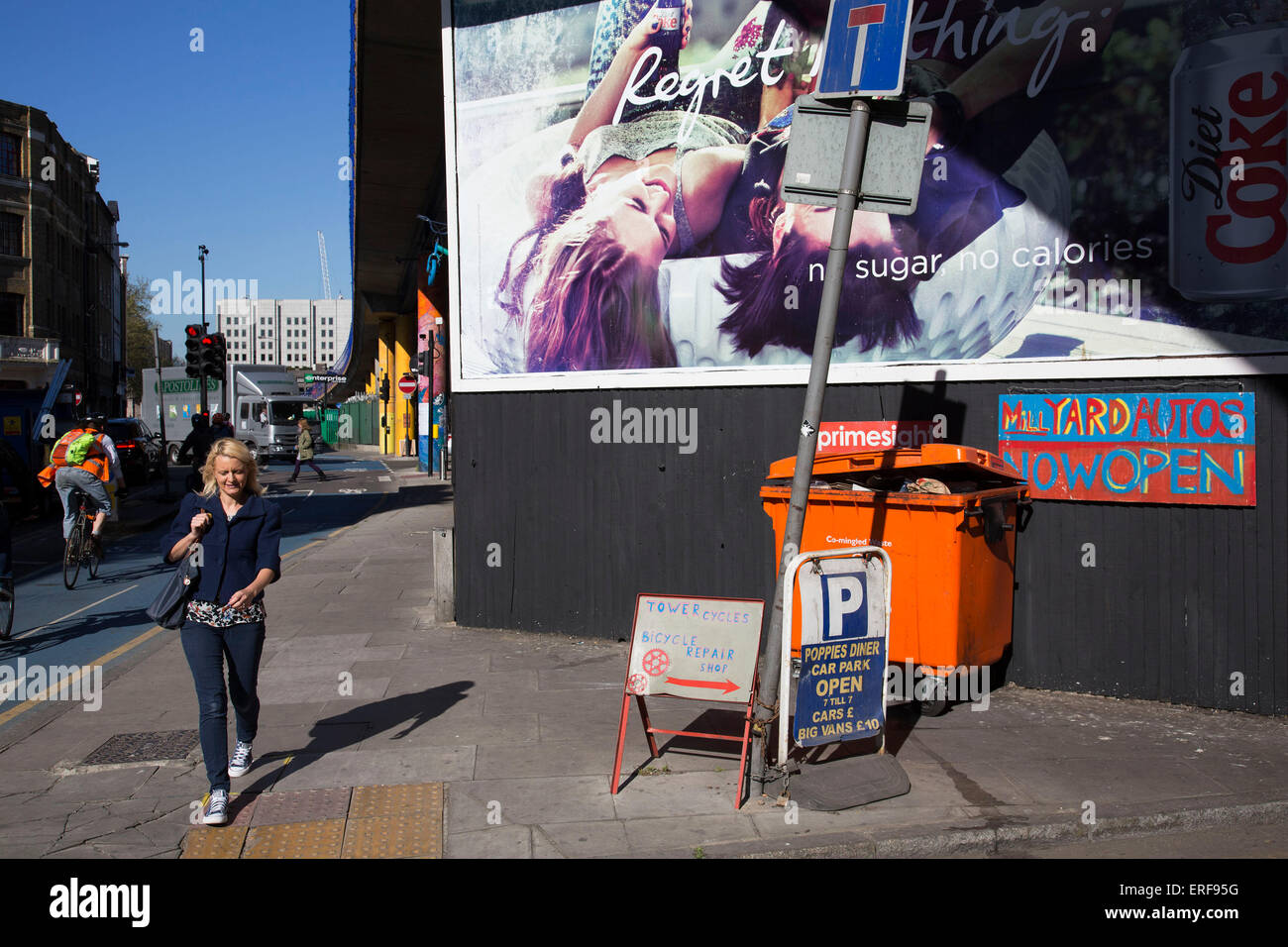 People passing an advertising billboard on a street corner on Cable ...