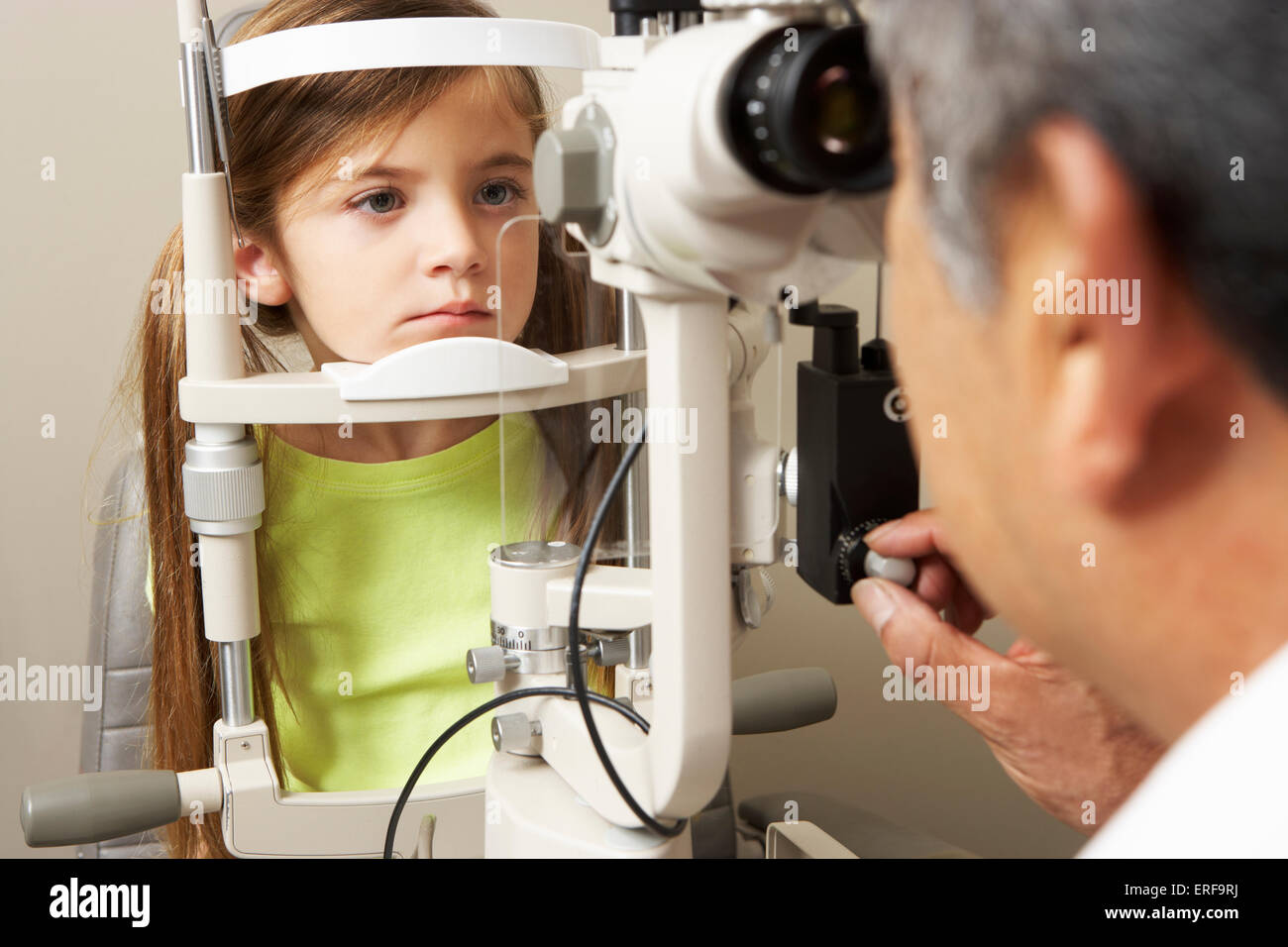Optician In Surgery Giving Girl Eye Test Stock Photo - Alamy