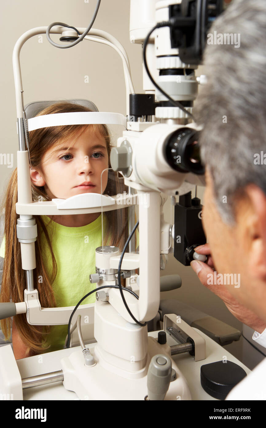 Optician In Surgery Giving Girl Eye Test Stock Photo - Alamy