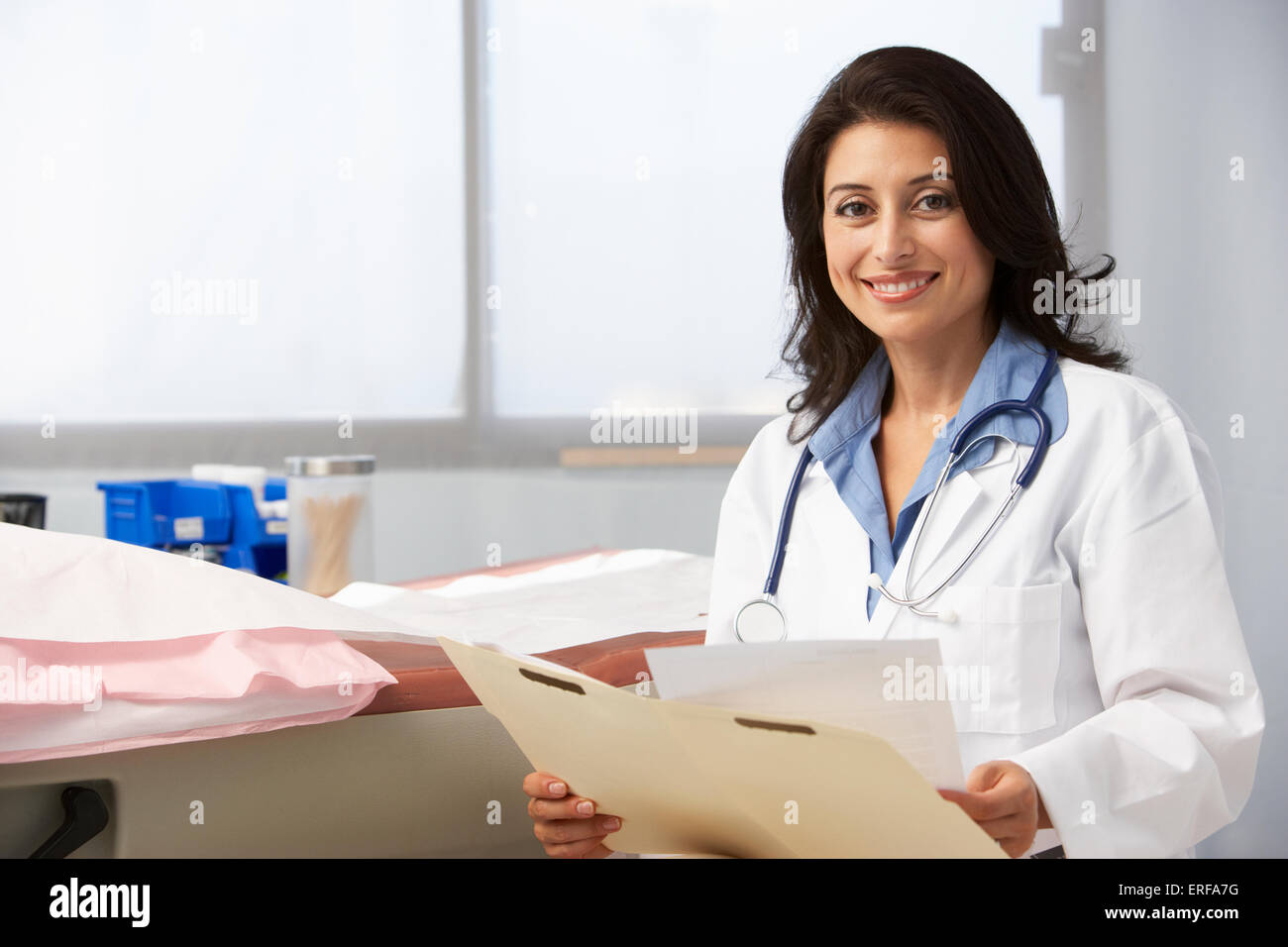 Female Doctor In Surgery Reading Patient Notes Stock Photo - Alamy
