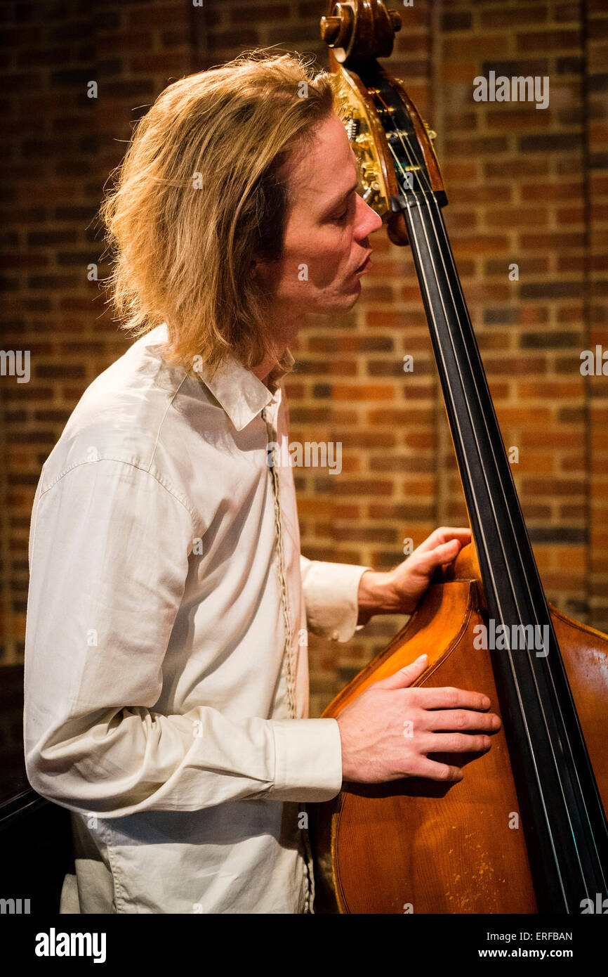Norwegian bass player Jasper Holby plaing double bass during sound ...