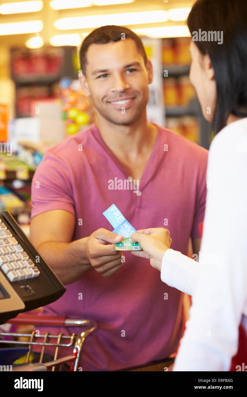 Customer using vouchers supermarket checkout hi-res stock photography ...
