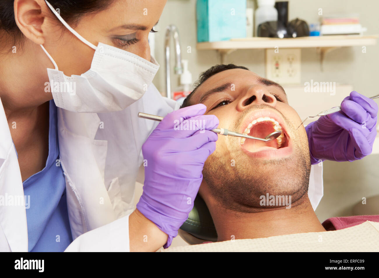 Man Having Check Up At Dentists Surgery Stock Photo - Alamy