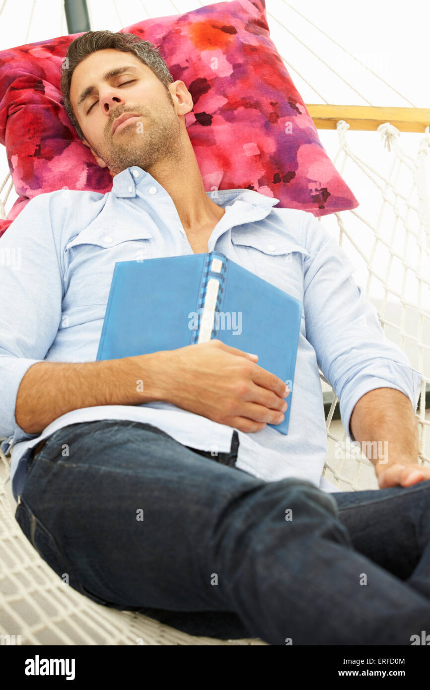 Man Sleeping In Garden Hammock Stock Photo - Alamy