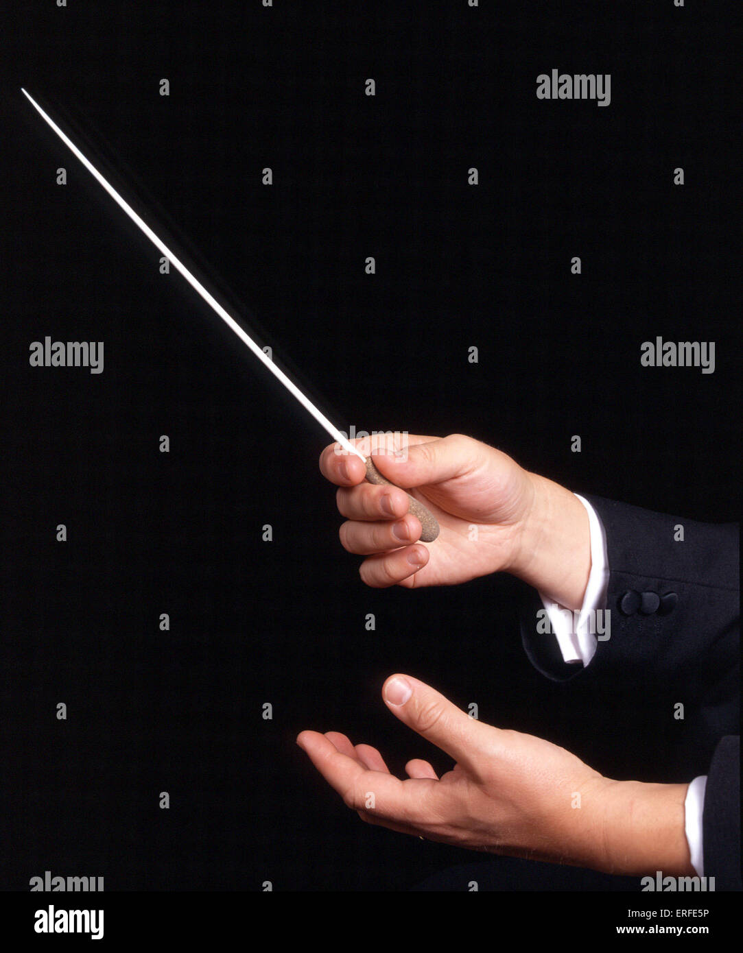Conductor 's hands pictured, one holding a baton Stock Photo - Alamy