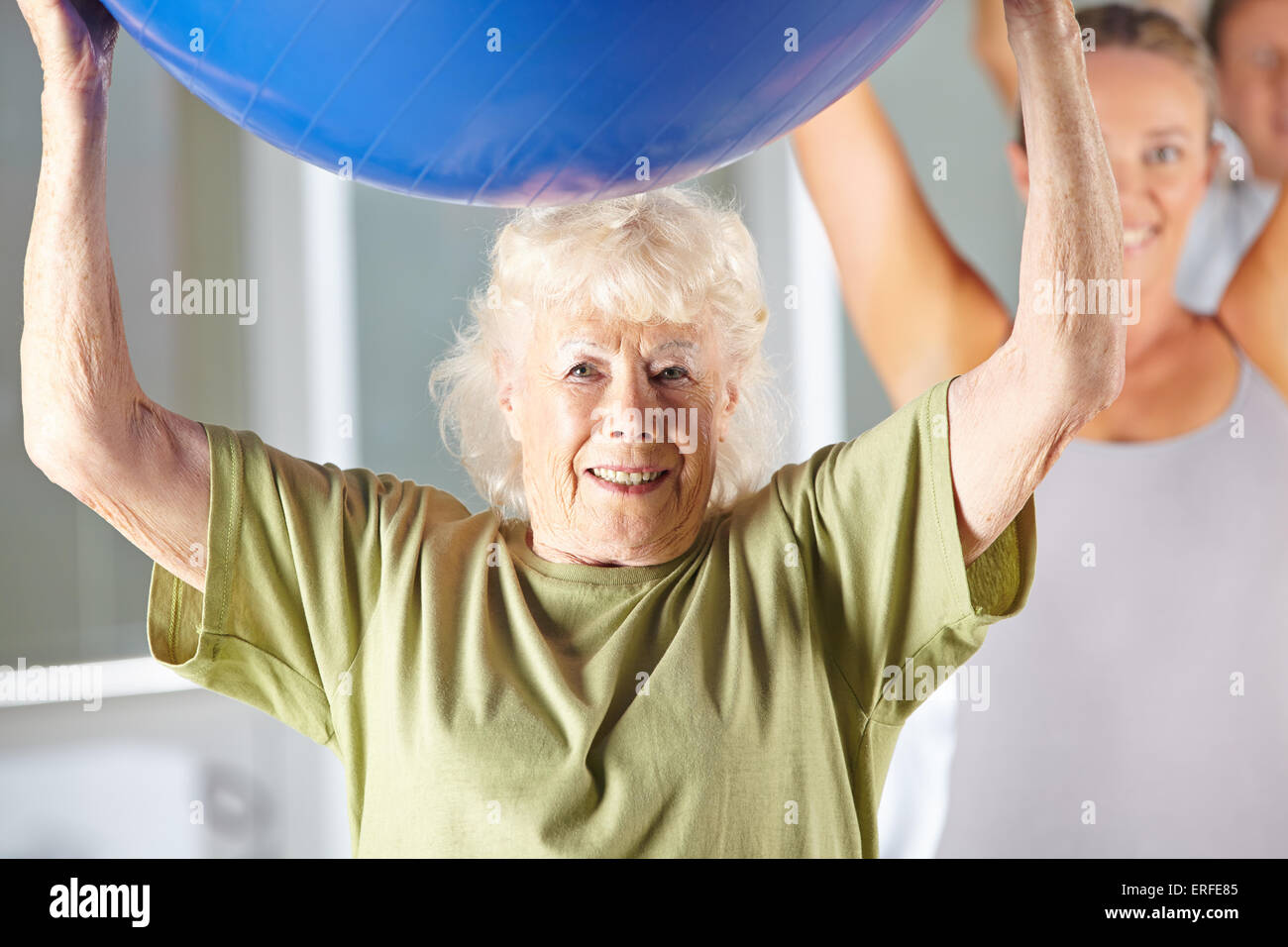 Old woman exercising with gym ball in fitness center in rehab Stock ...