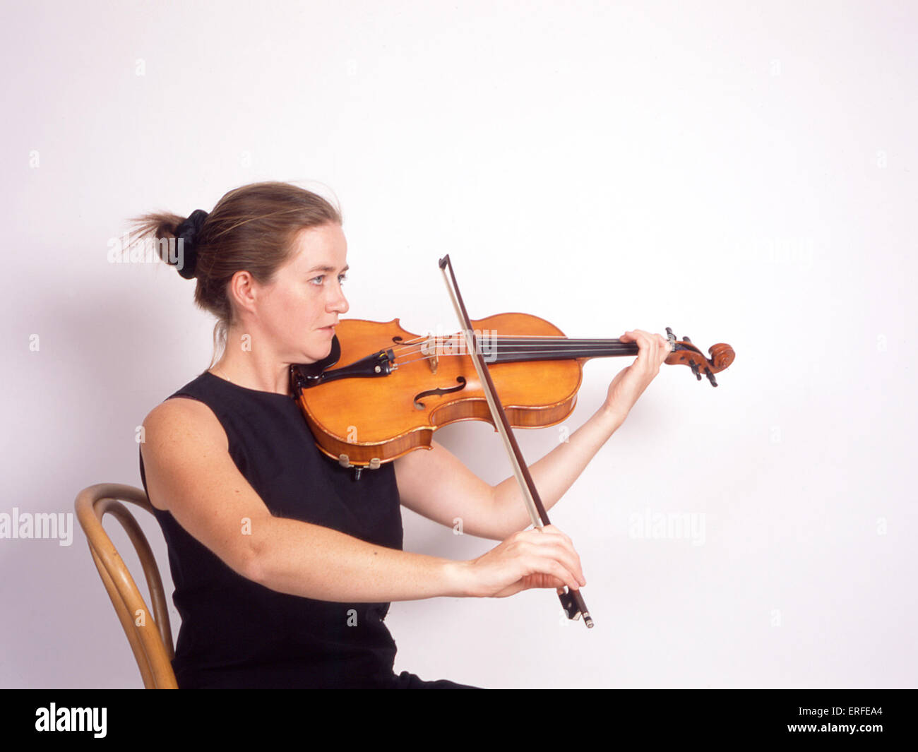 Viola - being played by woman player seated Stock Photo - Alamy