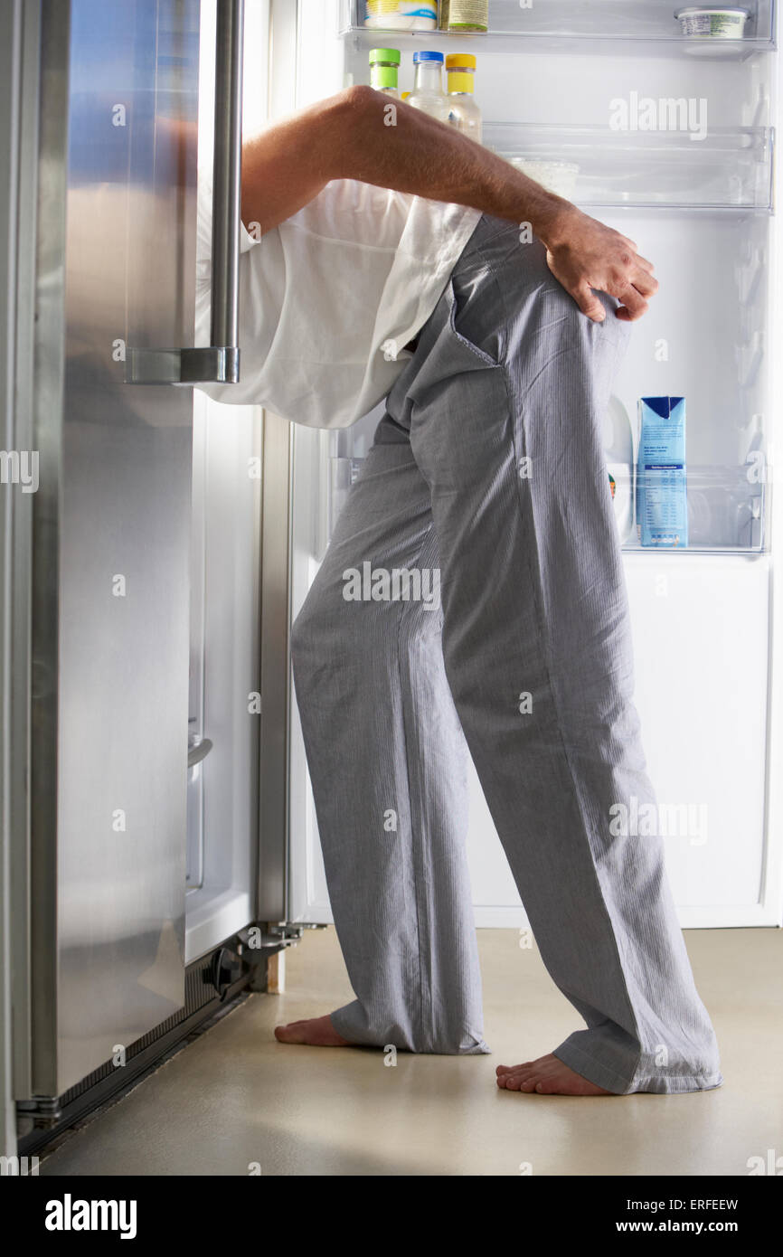 Man Raiding The Fridge At Night Stock Photo - Alamy