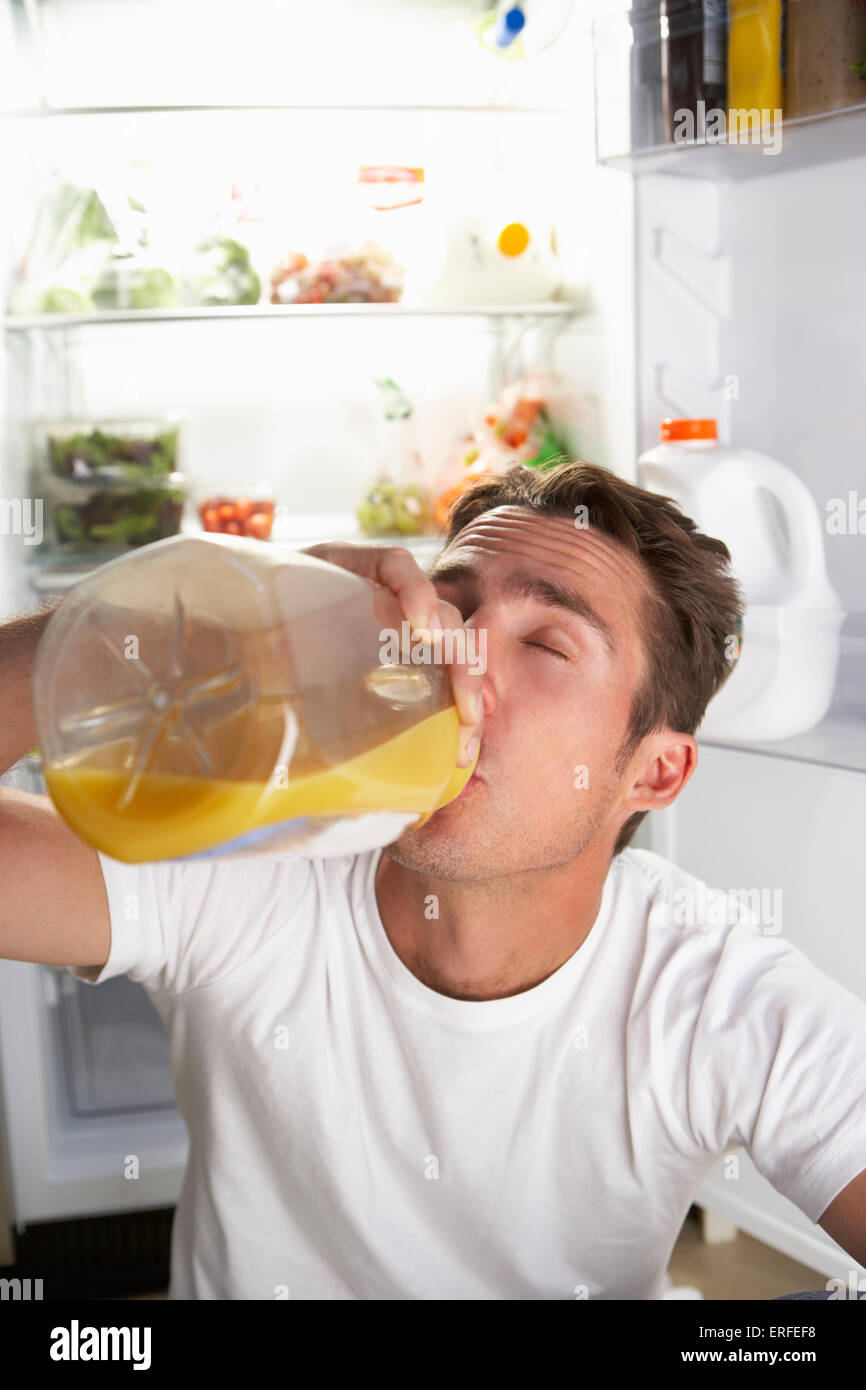 Man Raiding The Fridge For Drink At Night Stock Photo - Alamy