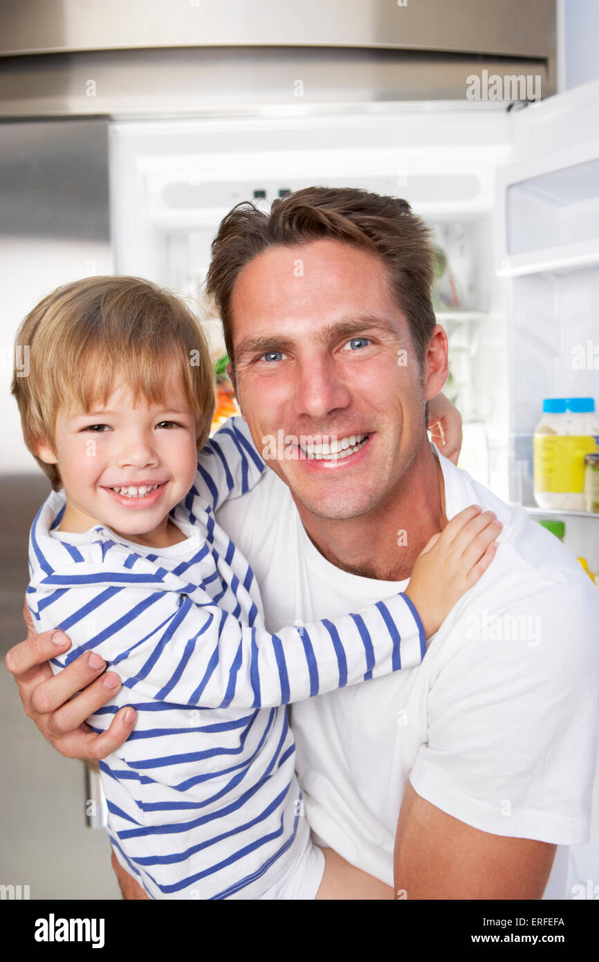 Father And Son Getting Snack From The Fridge Stock Photo - Alamy