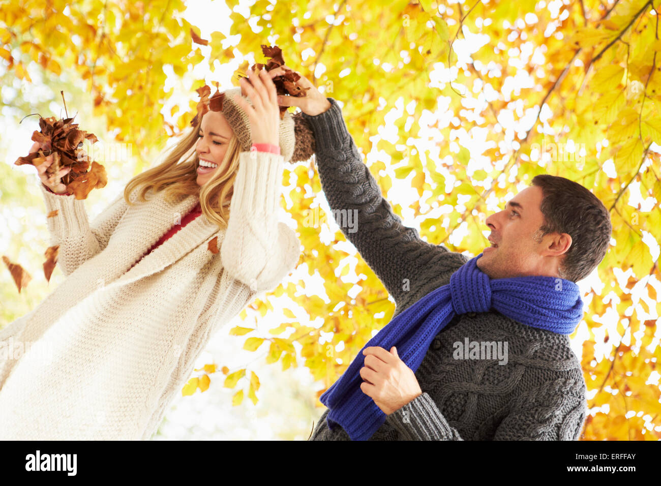 Couple Throwing Leaves In Autumn Garden Stock Photo - Alamy