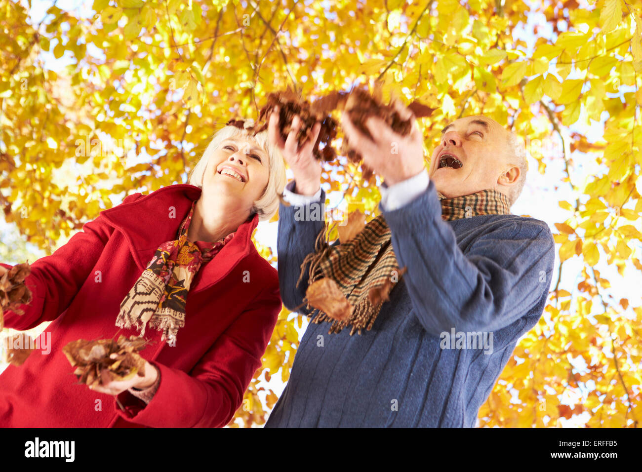 Senior Couple Throwing Leaves Into Air Stock Photo - Alamy