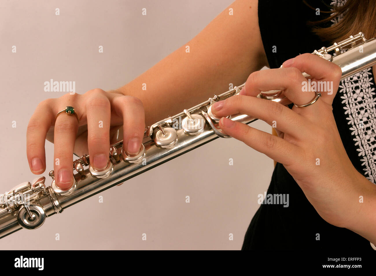 Flute - woman playing - close up showing fingers on keys demonstrating ...