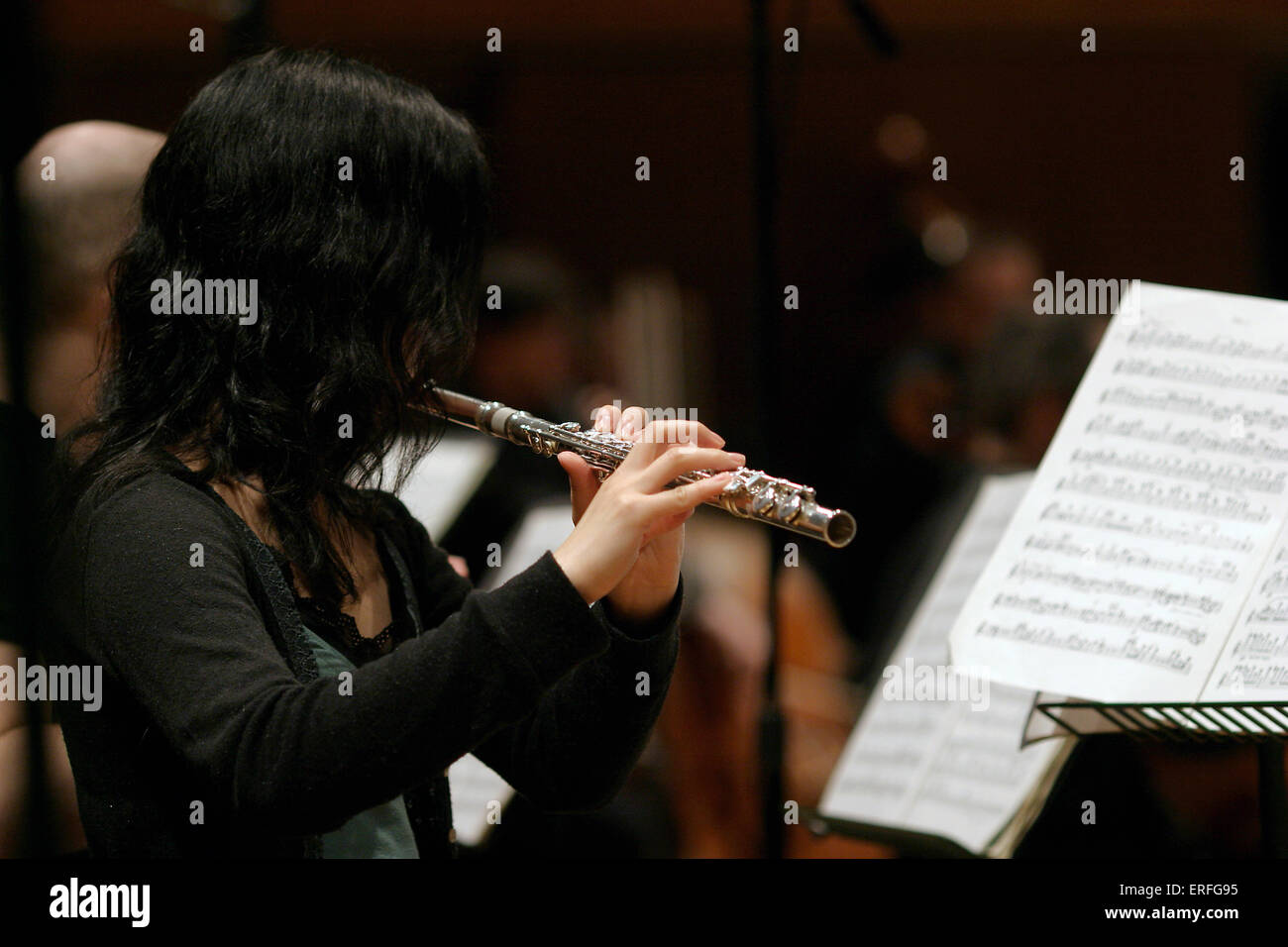 Flautist / flutist - player in playing position - with sheet music ...