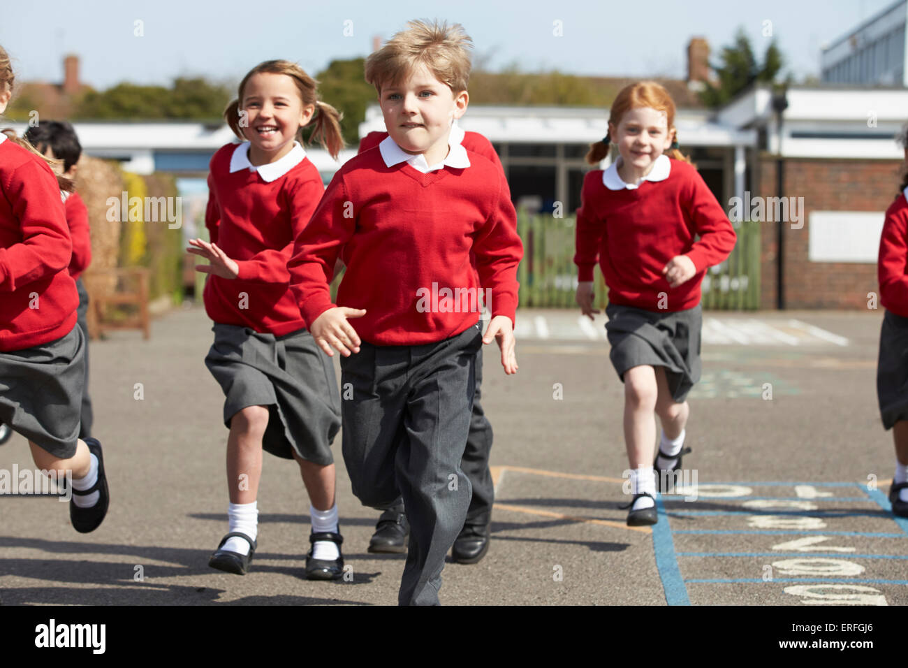 Elementary School Pupils Running In Playground Stock Photo - Alamy