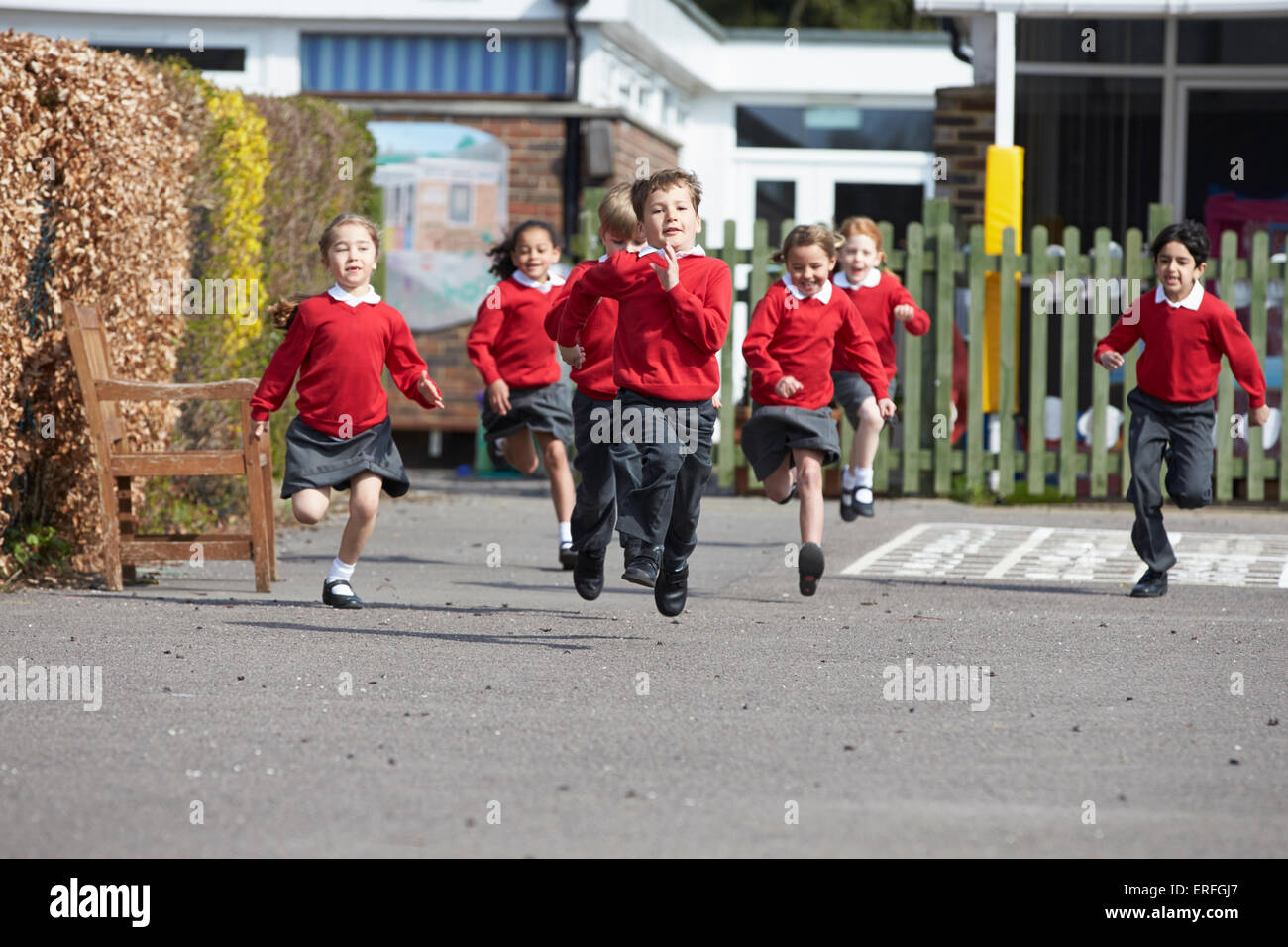 Elementary School Pupils Running In Playground Stock Photo - Alamy