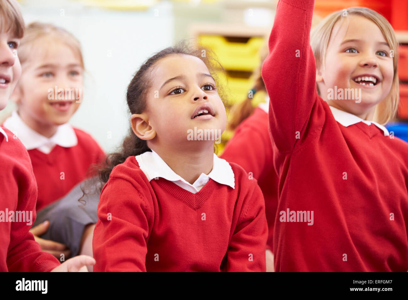 Pupils Sitting On Mat Listening To Teacher Stock Photo - Alamy