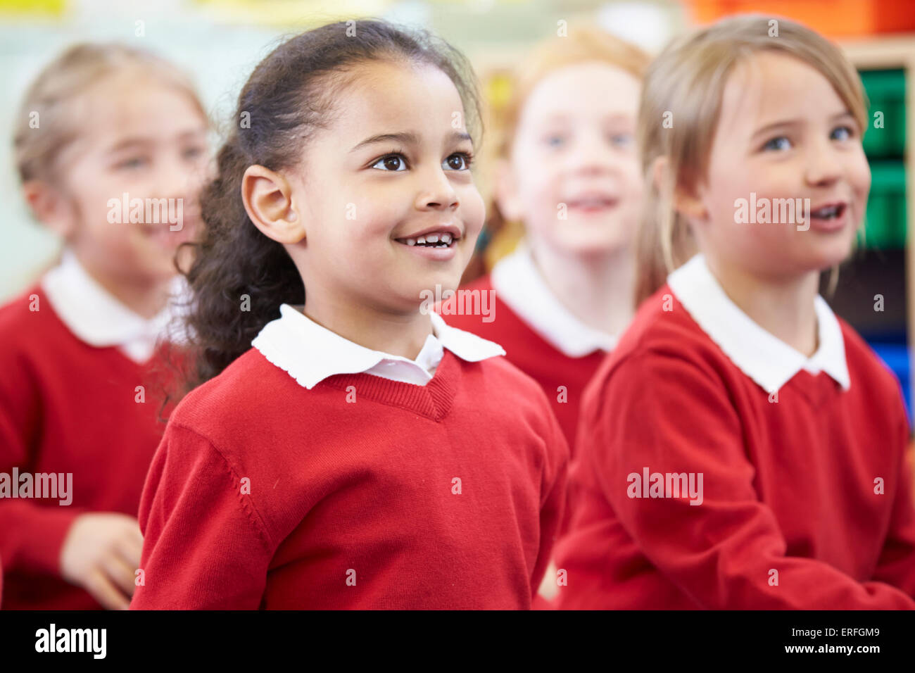 Pupils Sitting On Mat Listening To Teacher Stock Photo - Alamy
