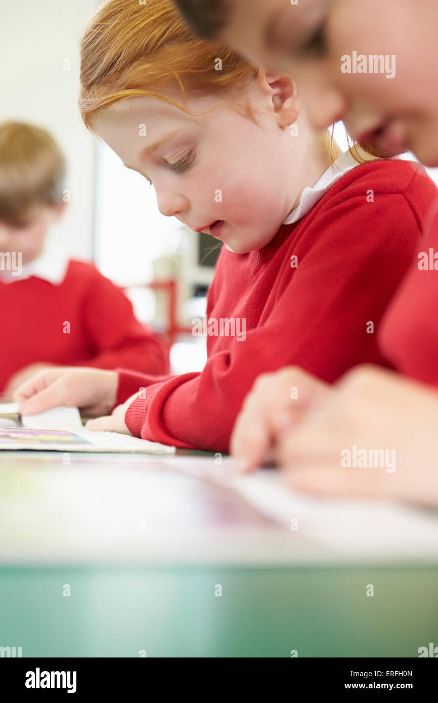 Female Pupil Reading Book At Table Stock Photo - Alamy