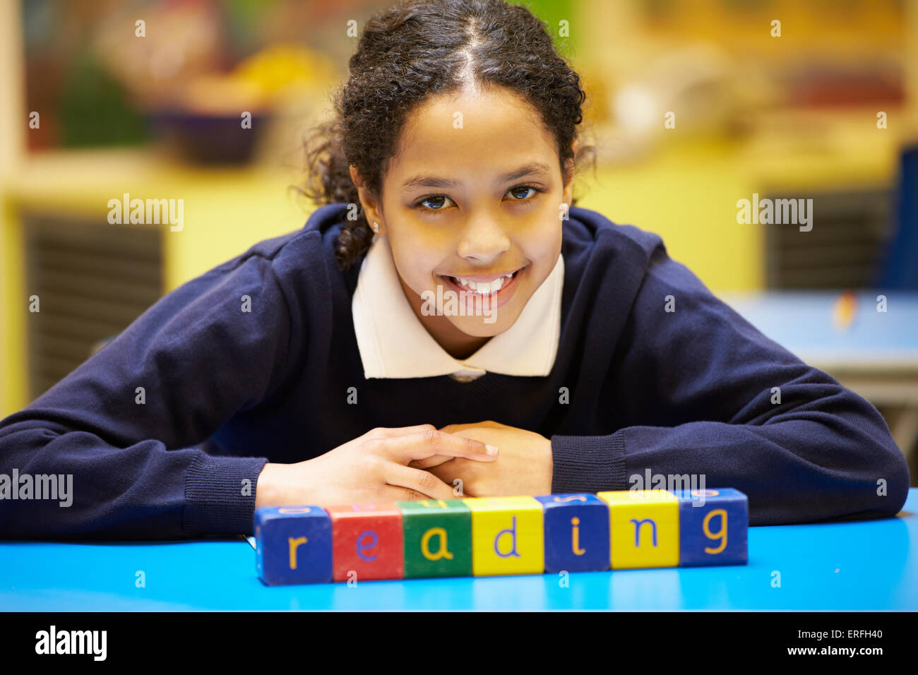Word "Reading" Spelt In Wooden Blocks With Pupil Behind Stock Photo - Alamy