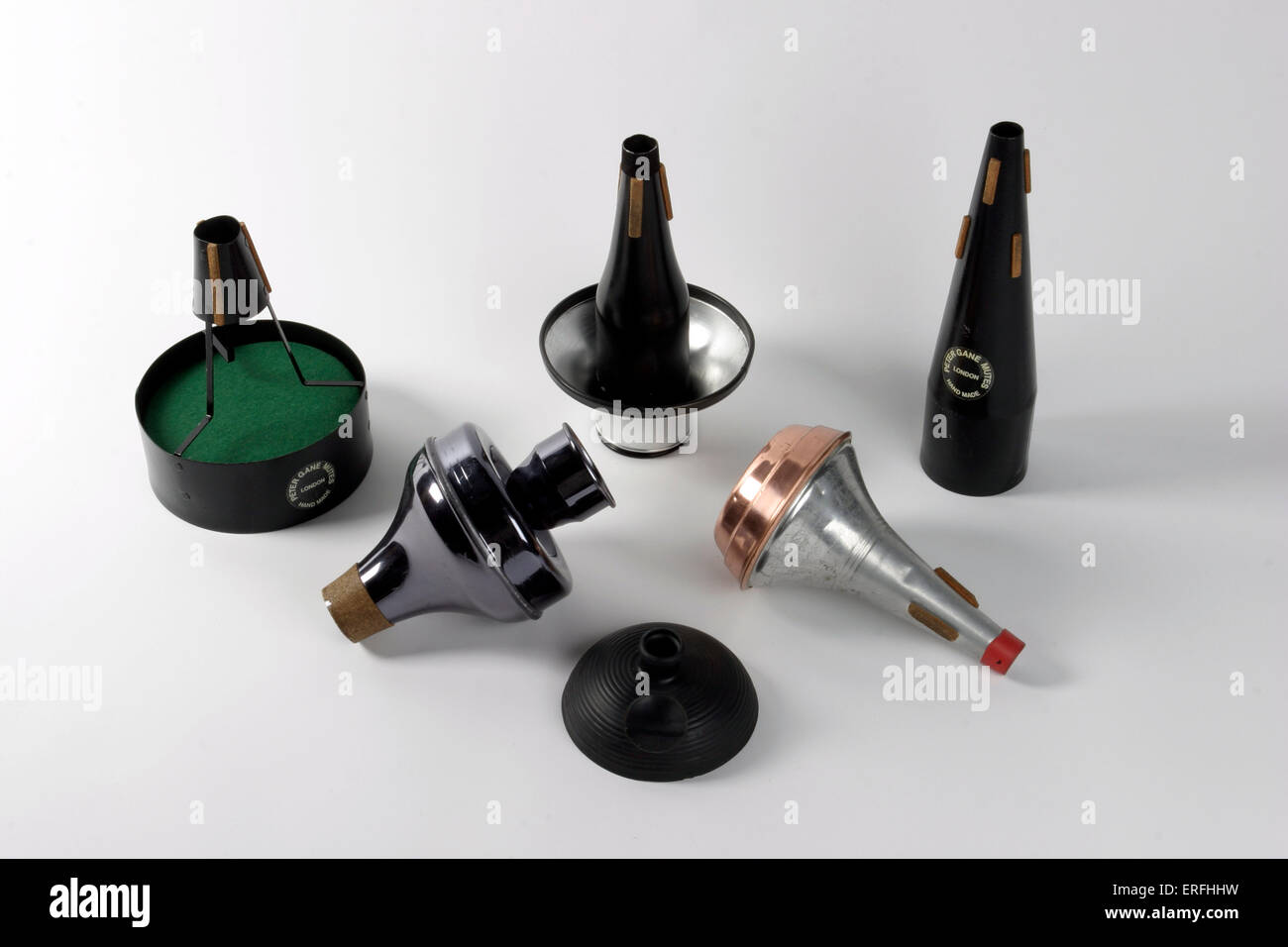 Trombone mutes White background Stock Photo - Alamy
