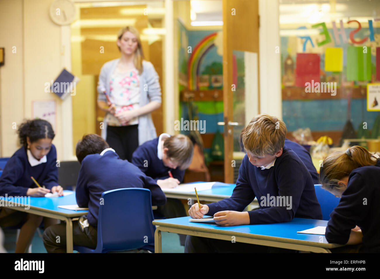 Elementary School Pupils Sitting Examination In Classroom Stock Photo ... Elementary School Pupils Sitting Examination In Classroom Stock Photo ...