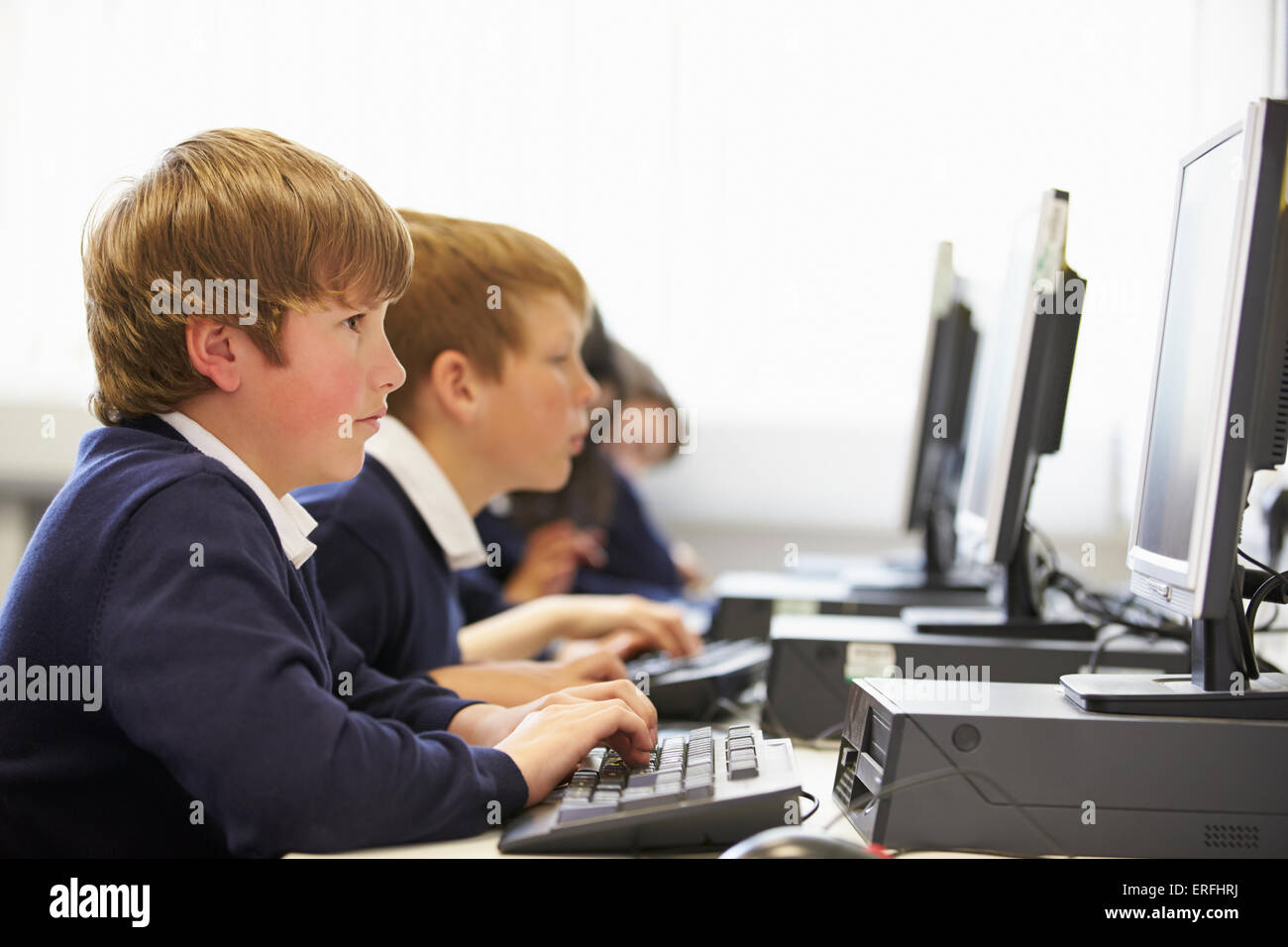 Line Of Children In School Computer Class Stock Photo - Alamy