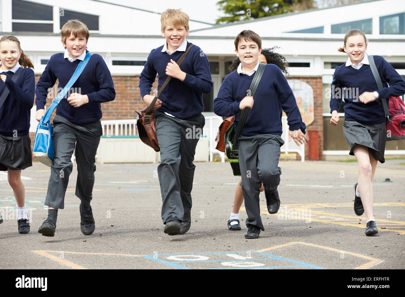 Group Of Elementary School Pupils Running In Playground Stock Photo - Alamy