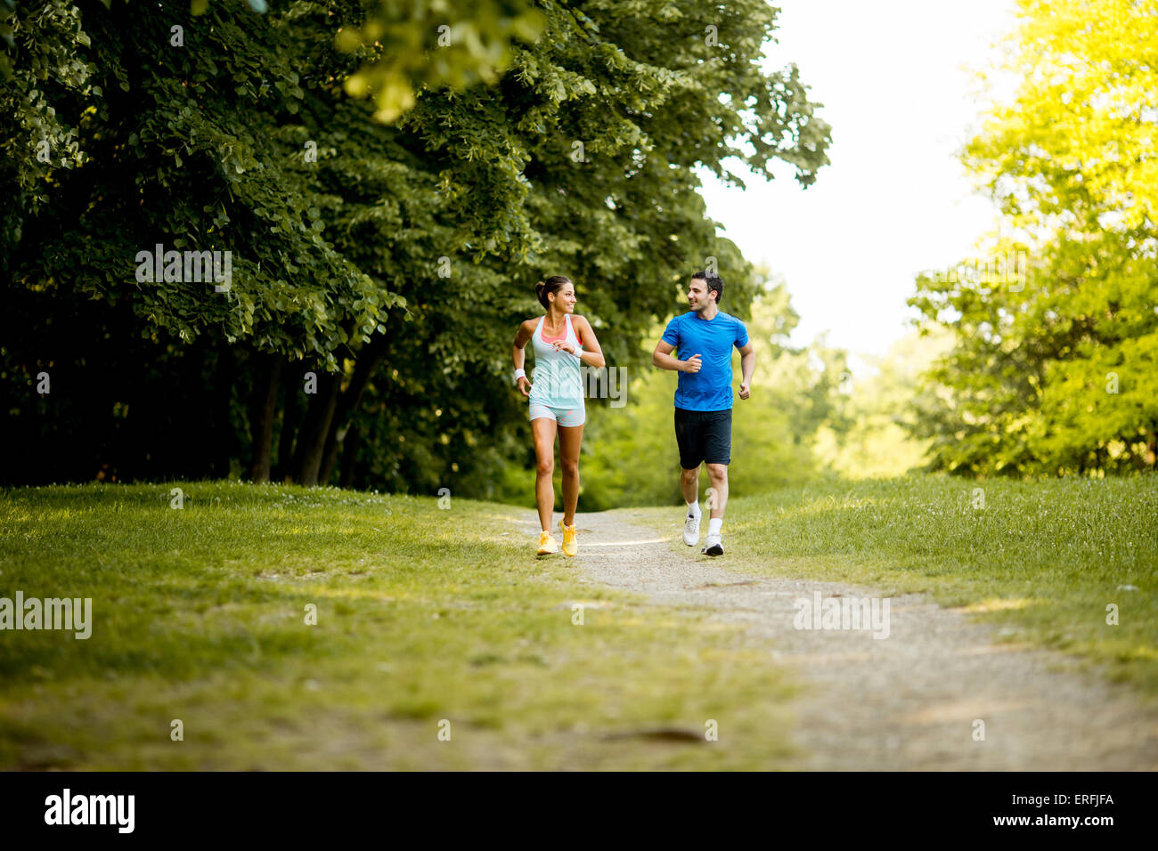 Young couple running Stock Photo - Alamy