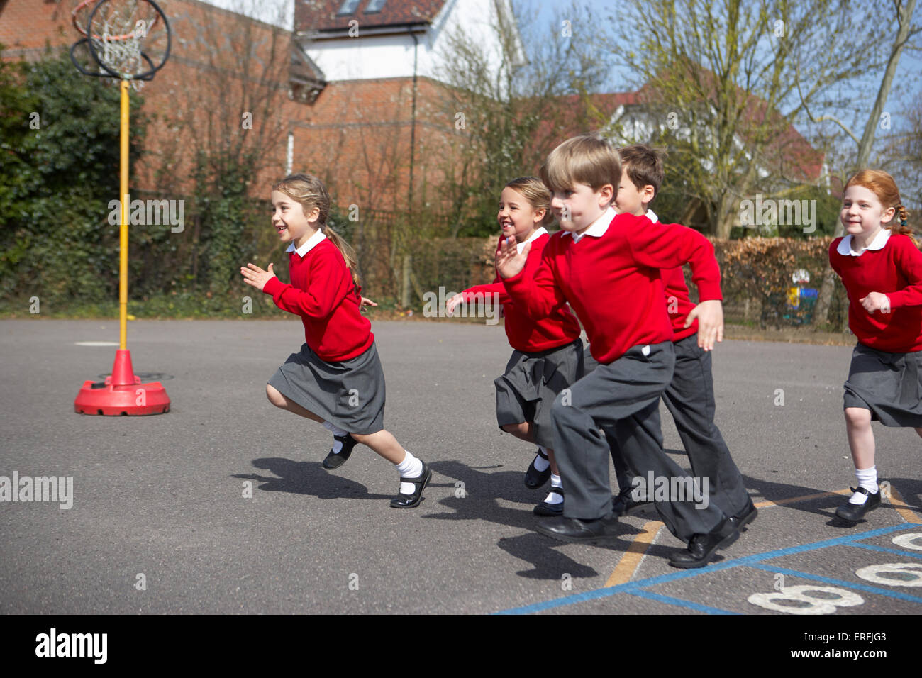 Group Of Elementary School Pupils Running In Playground Stock Photo - Alamy