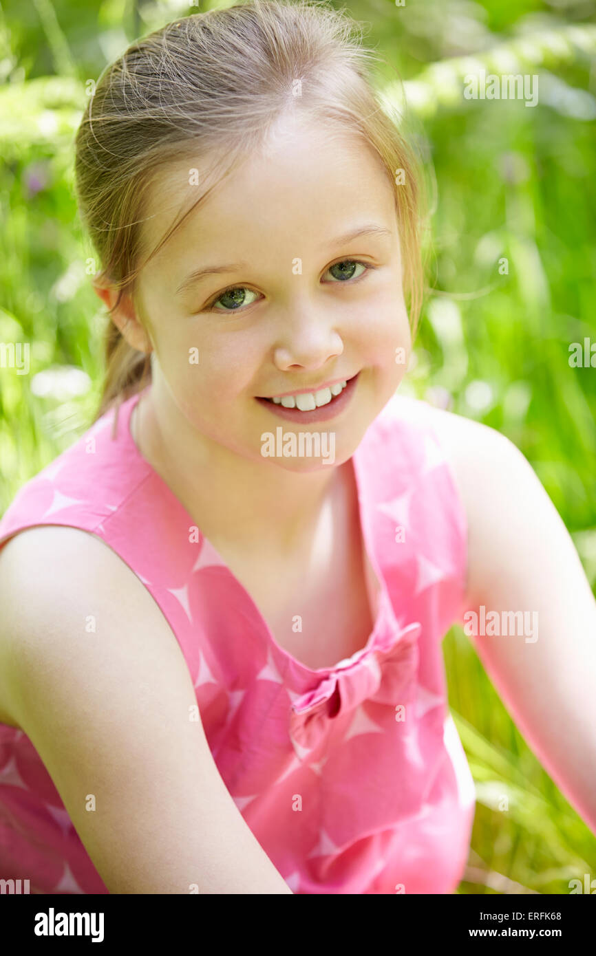 Portrait Of Young Girl Sitting In Field Stock Photo - Alamy
