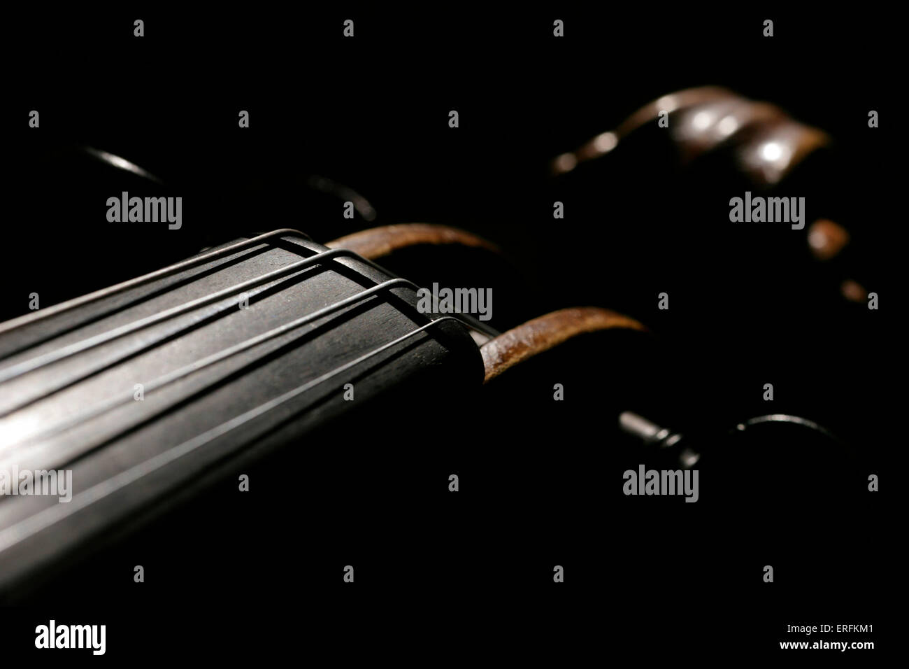 Violin - close-up of fingerboard, strings, and scroll. Black background ...