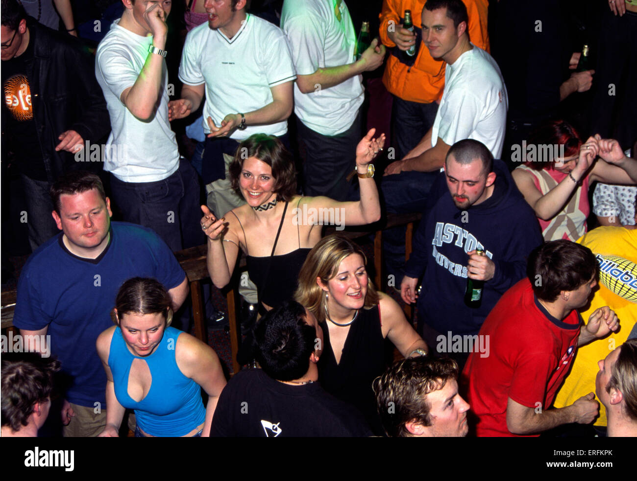 Disco - young people dancing in a club to DJ 's music, 2000. View from ...