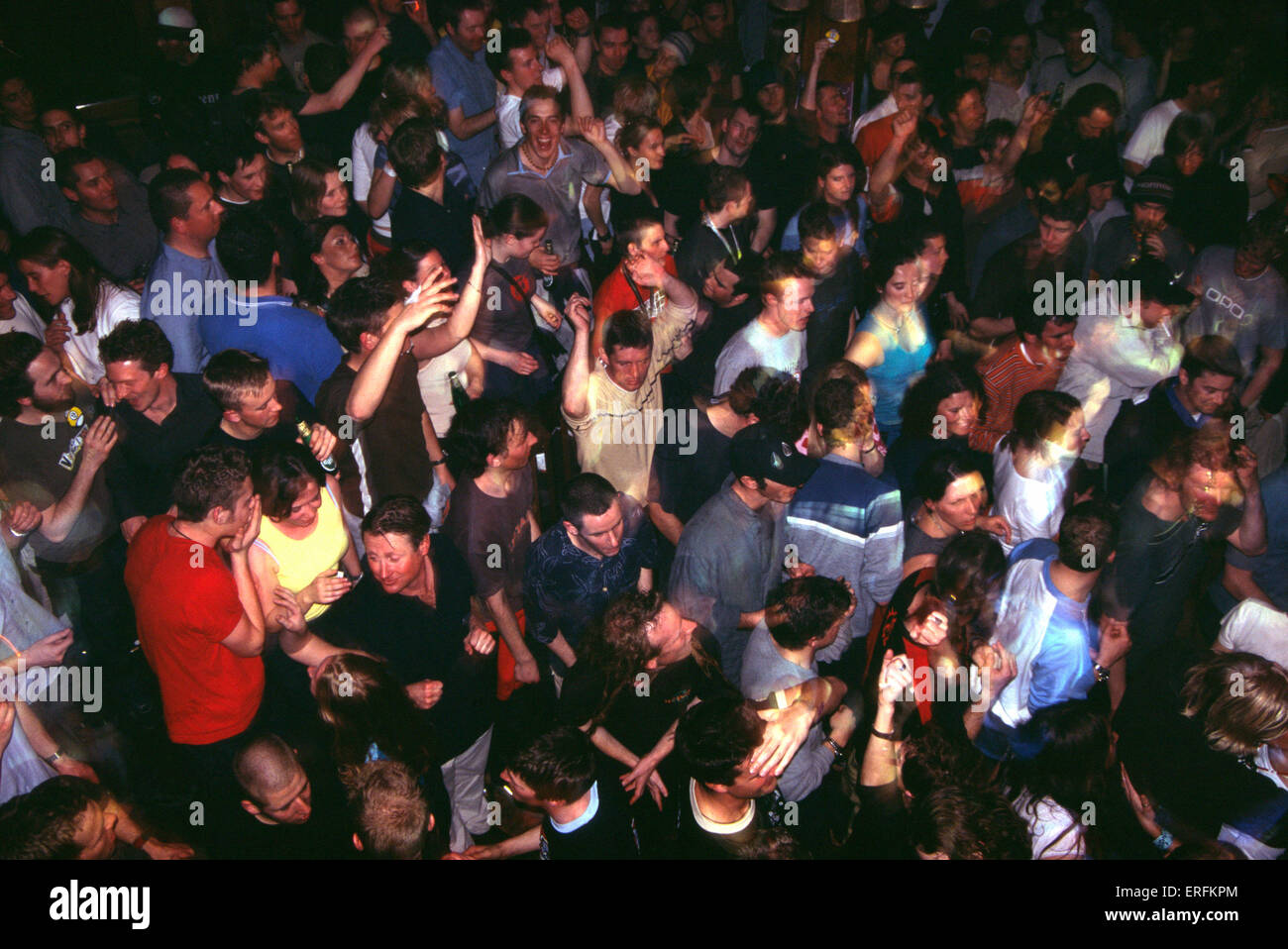 Disco - young people dancing in a club to DJ 's music, 2000. View from ...
