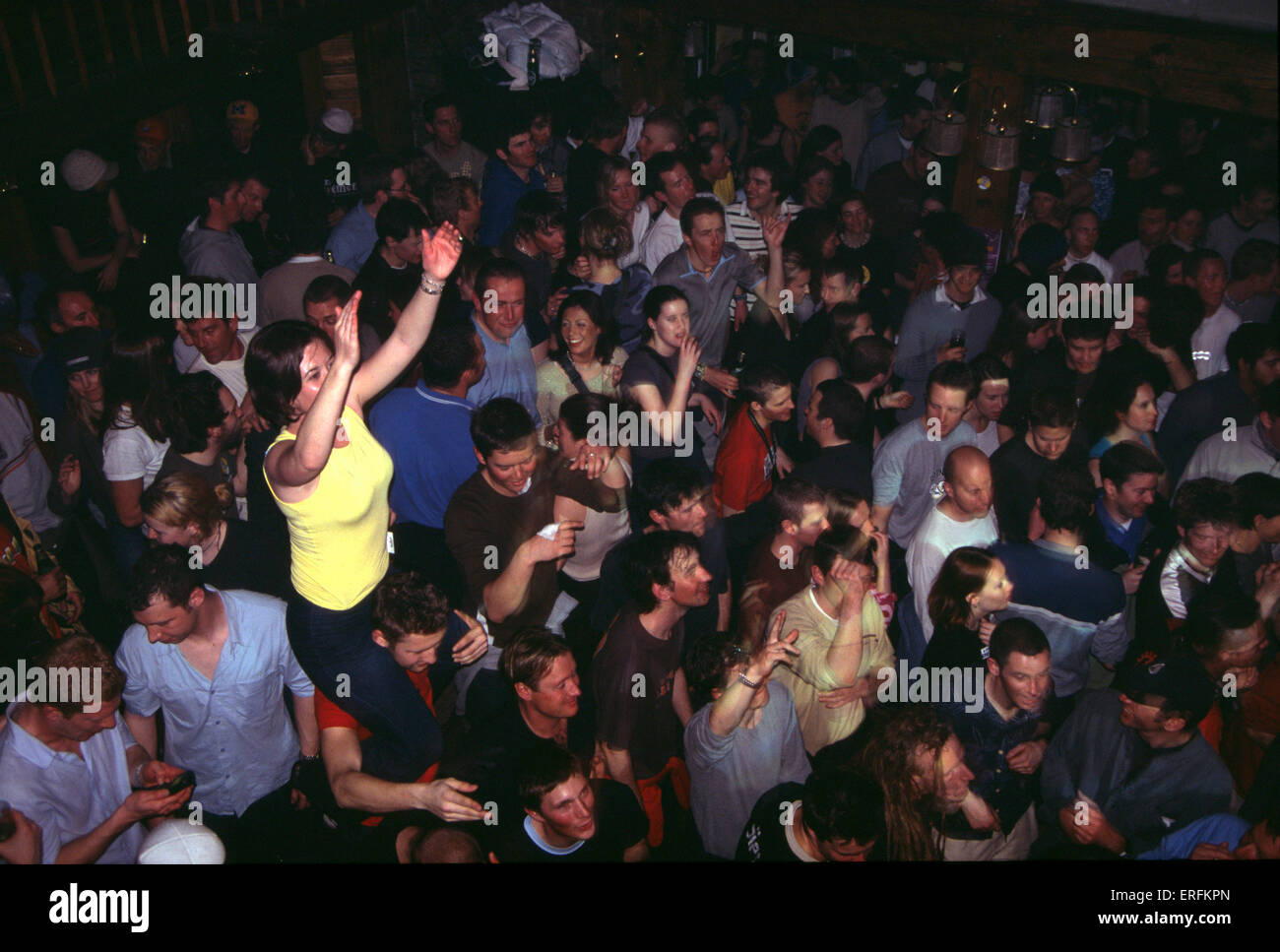 Disco - young people dancing in a club to DJ 's music, 2000. View from ...