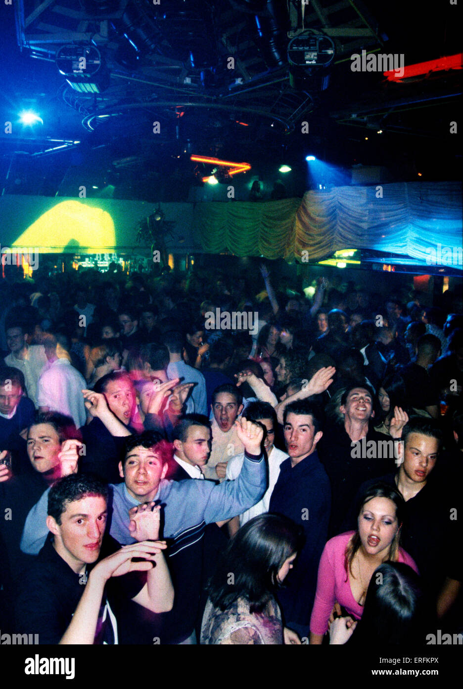 Disco - young people dancing in a club to DJ 's music, 2000. View from ...
