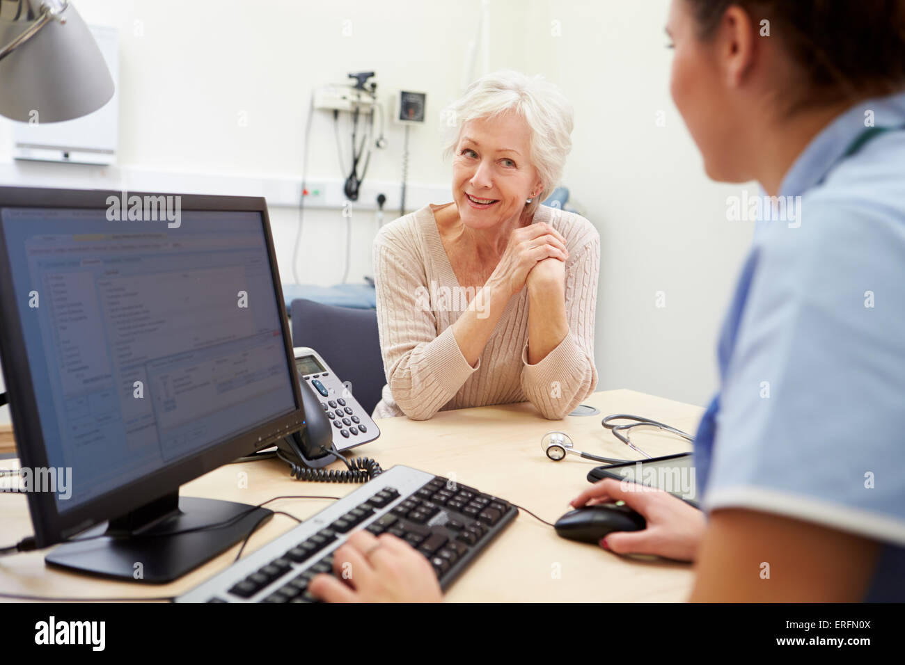 Senior Female Patient Has Appointment With Nurse Stock Photo - Alamy