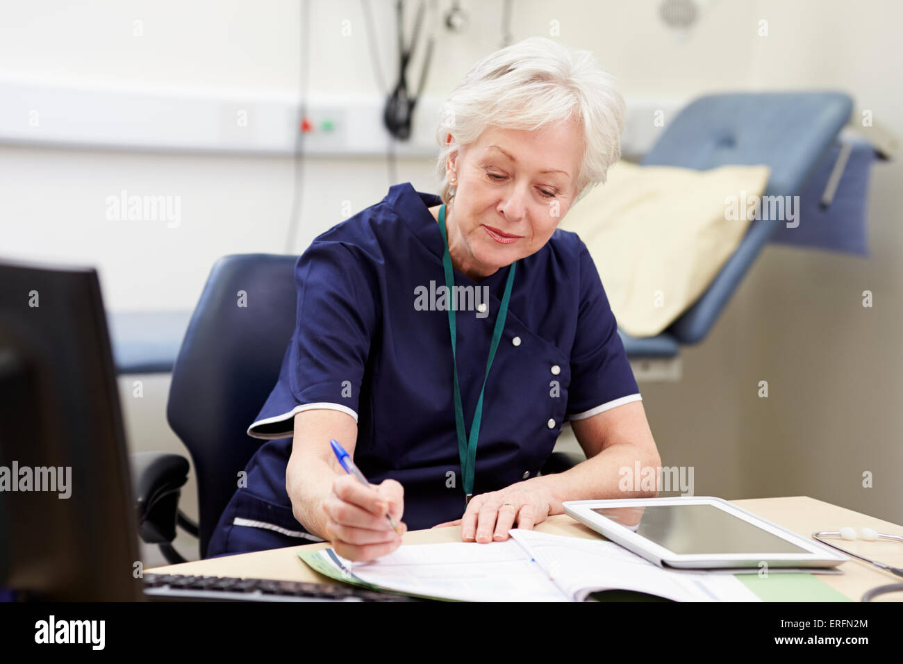 Female Nurse Working At Desk In Office Stock Photo - Alamy