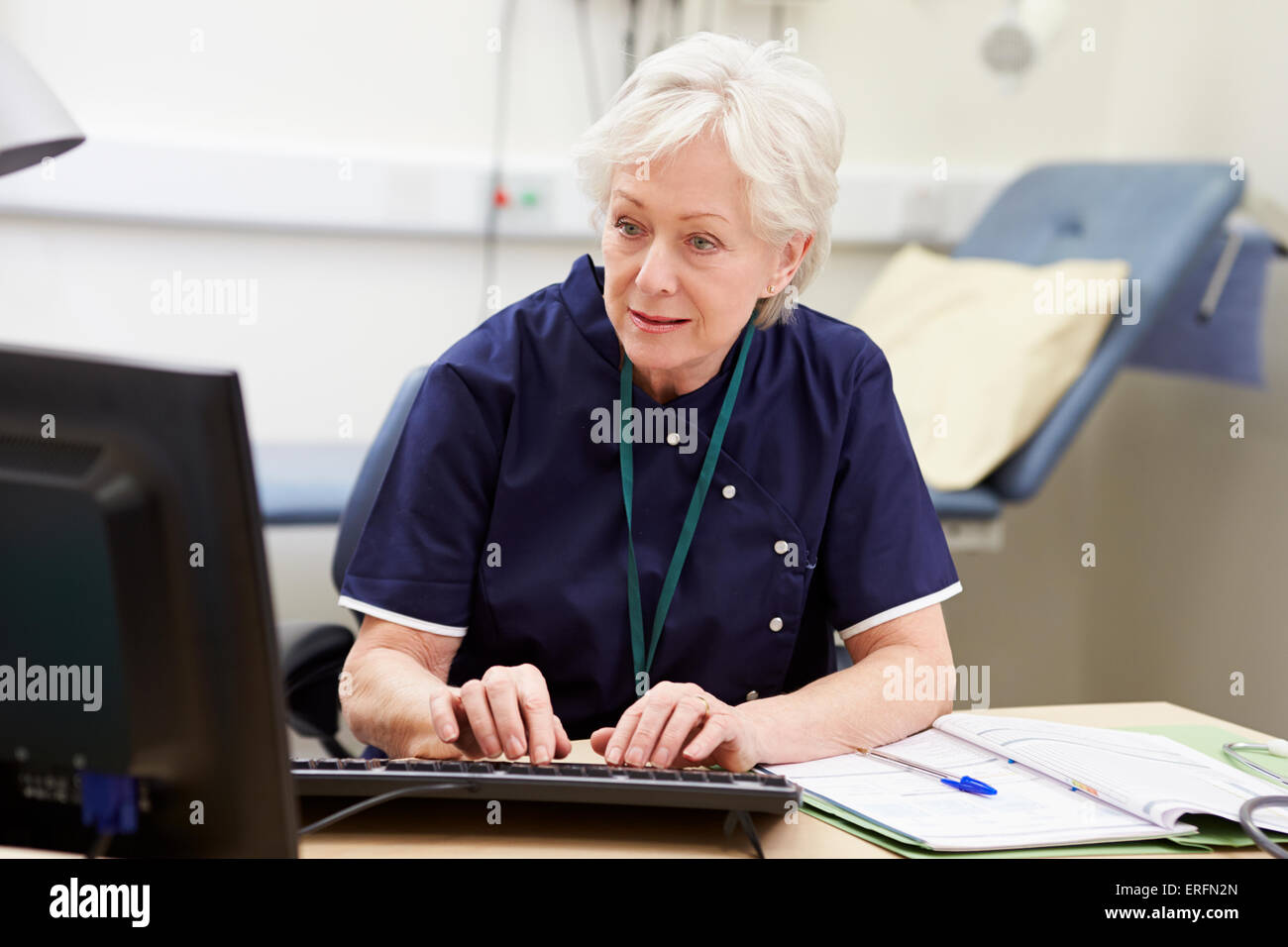 Female Nurse Working At Desk In Office Stock Photo - Alamy