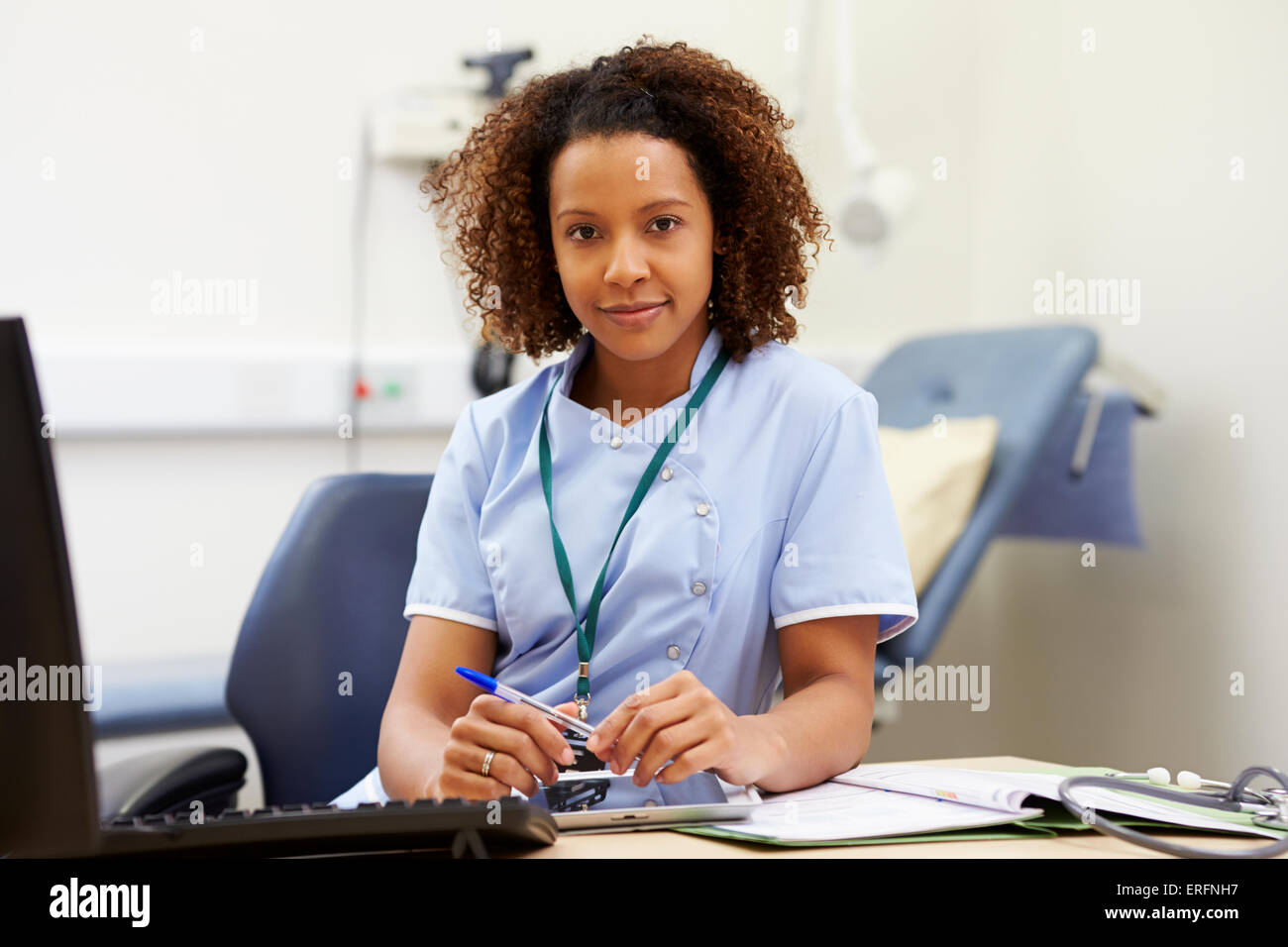Portrait Of Female Nurse Working At Desk In Office Stock Photo - Alamy