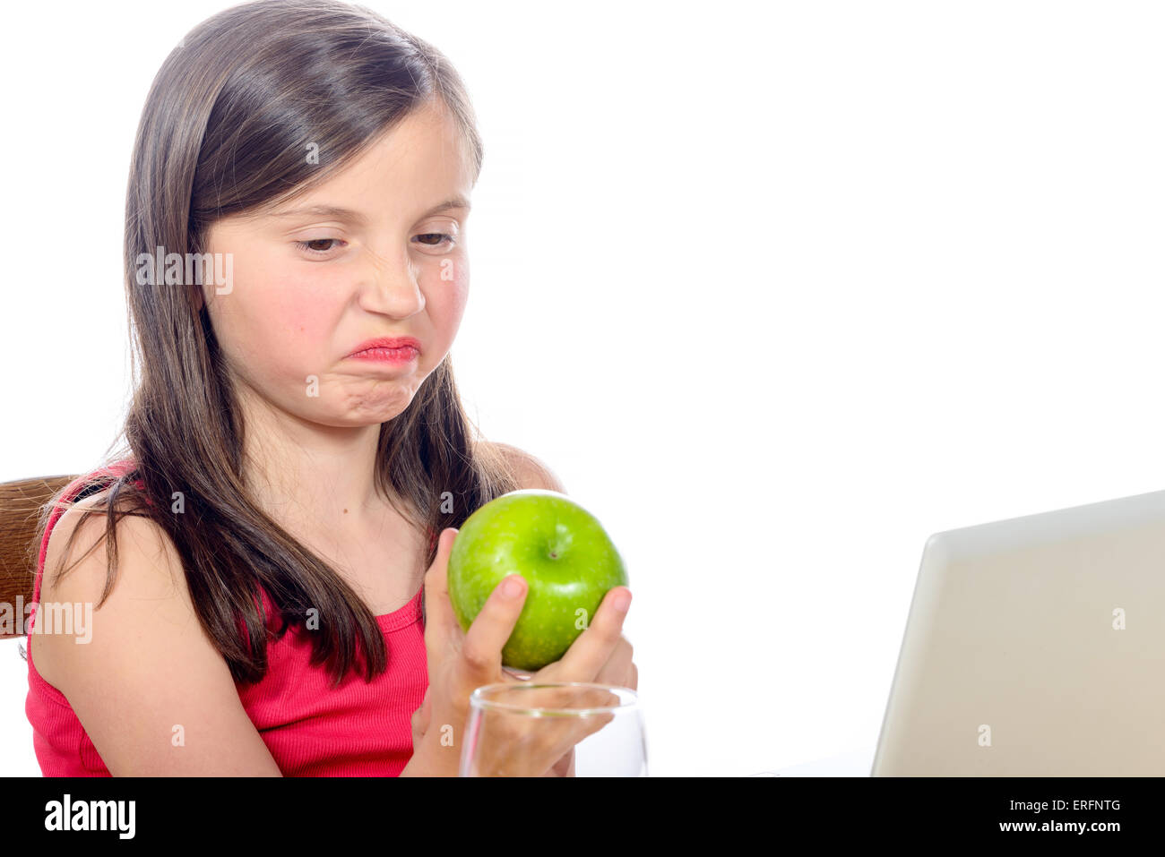 a little girl does not like apples on white background Stock Photo - Alamy