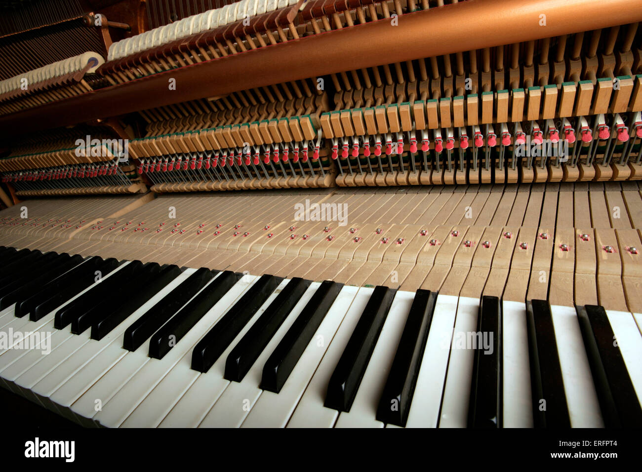 Interior of an upright piano - showing the keyboard and the mechanics ...