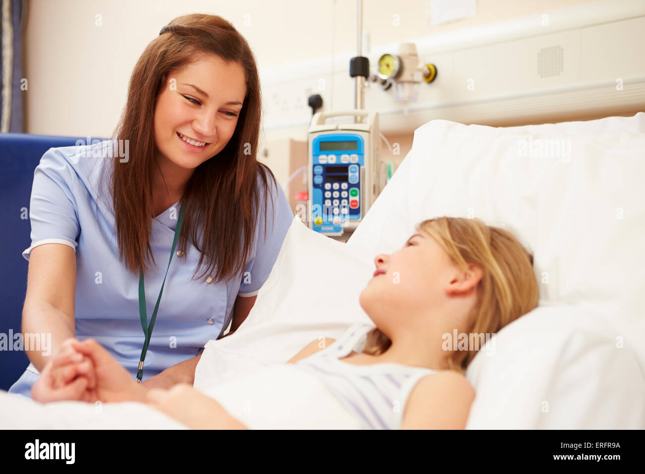 Nurse Sitting By Young Girl's Bed In Hospital Stock Photo - Alamy
