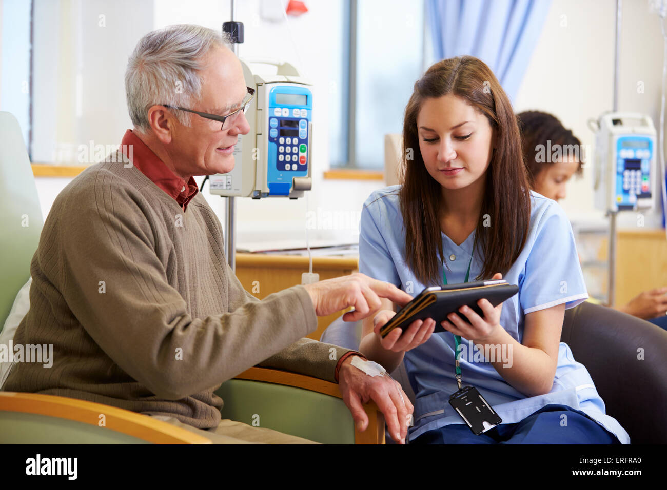 Man Having Chemotherapy With Nurse Using Digital Tablet Stock Photo - Alamy