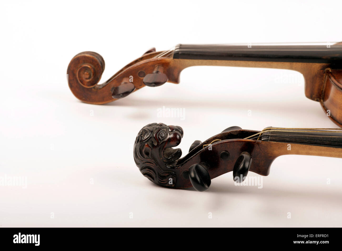 Two violin scrolls - both German. One standard, the other a carved ...