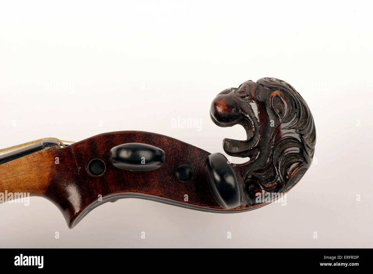 Violin scroll - carved in the shape of a lions head, with gut strings ...