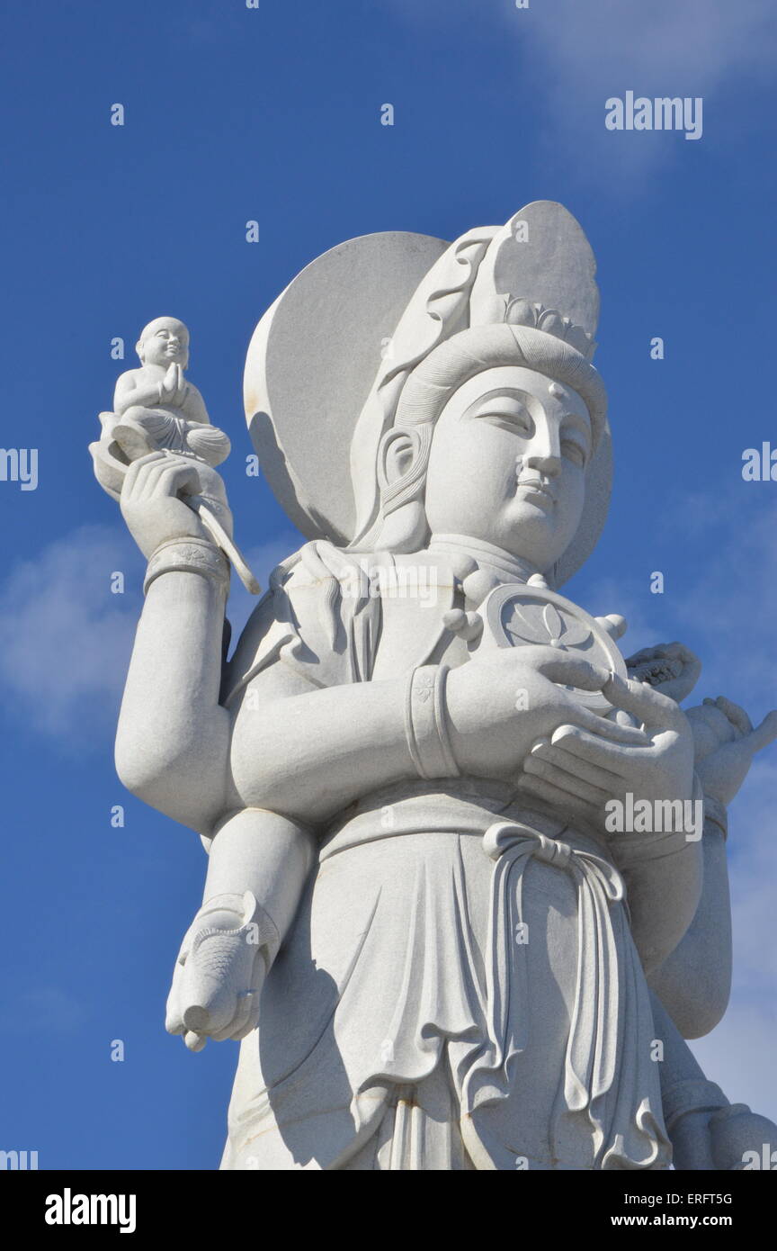 Buddhist statue of a goddess with the sky as background Stock Photo - Alamy