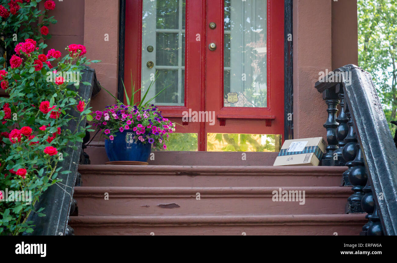 A parcel from Amazon prime sits on the stoop in front of a brownstone ...