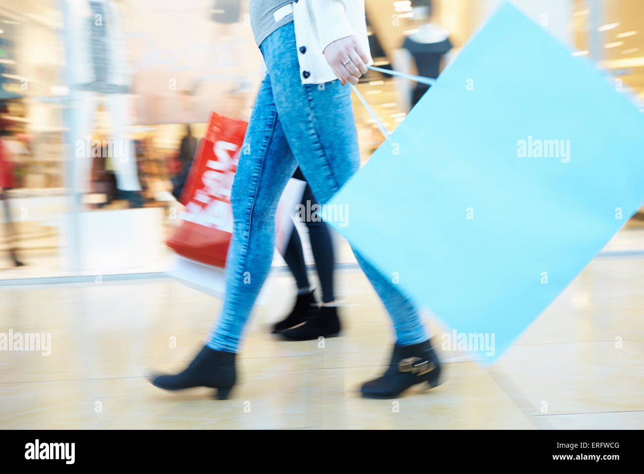 Close Up Of Shoppers Feet Carrying Bags In Shopping Mall Stock Photo ...